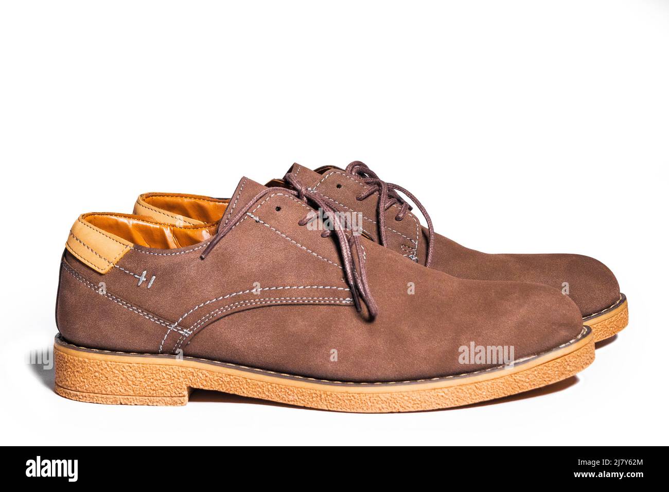 Side view of men's brown lace-up low shoes made of suede isolated on a ...