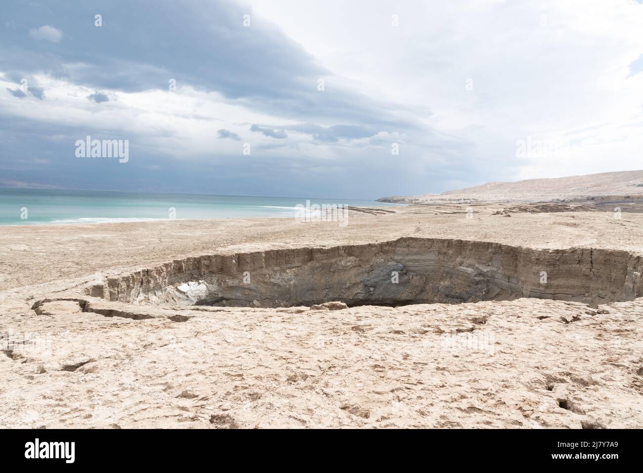 Sinkhole filled with turquoise water, near Dead Sea coastline. Hole ...