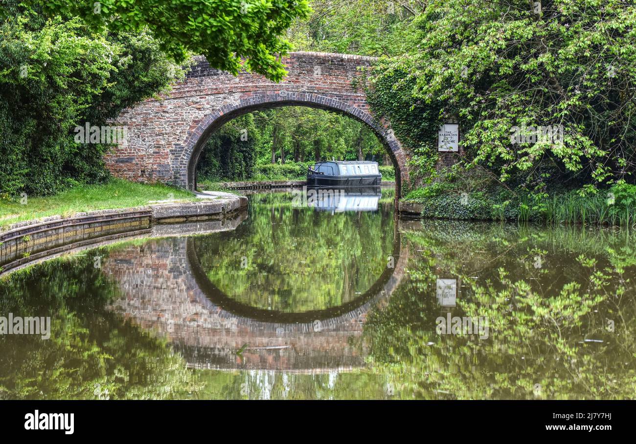 An old bridge reflected in the perfectly still waters of the Grand ...