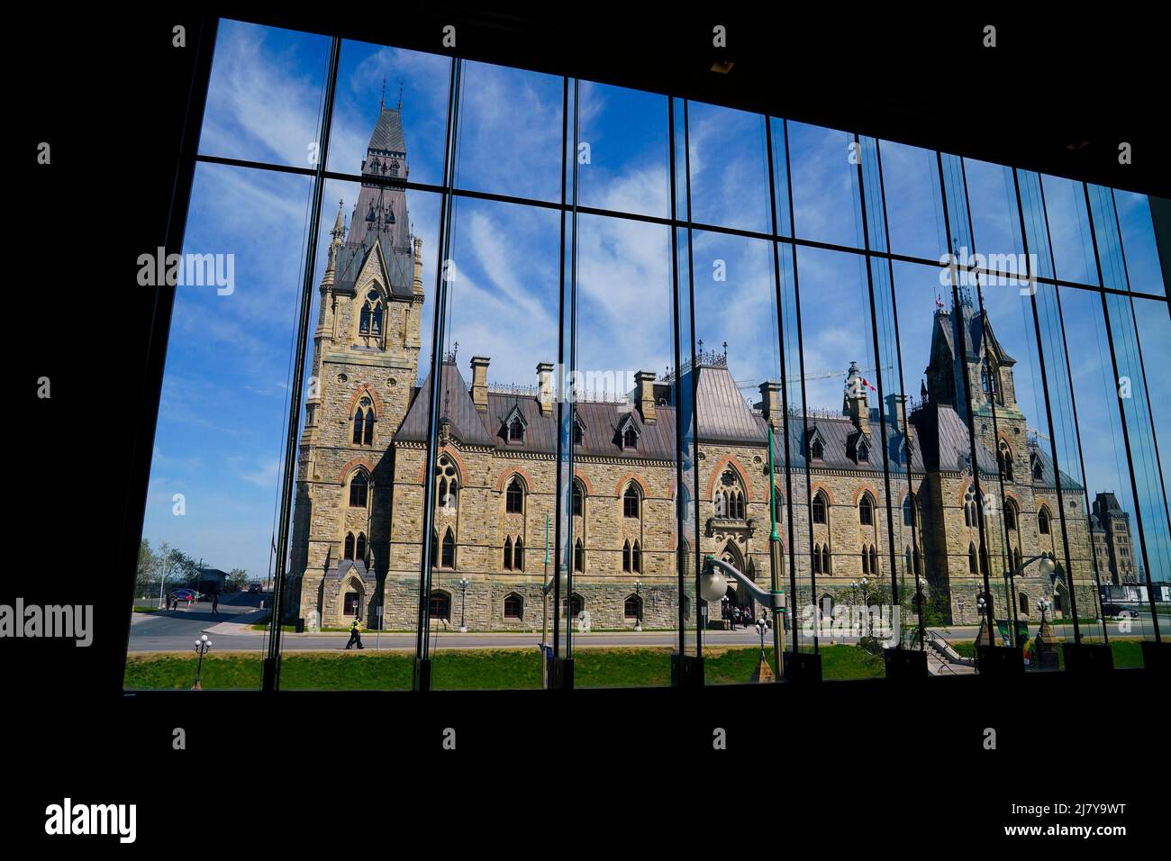 The West Block of Parliament Hill is pictured through the window of the ...