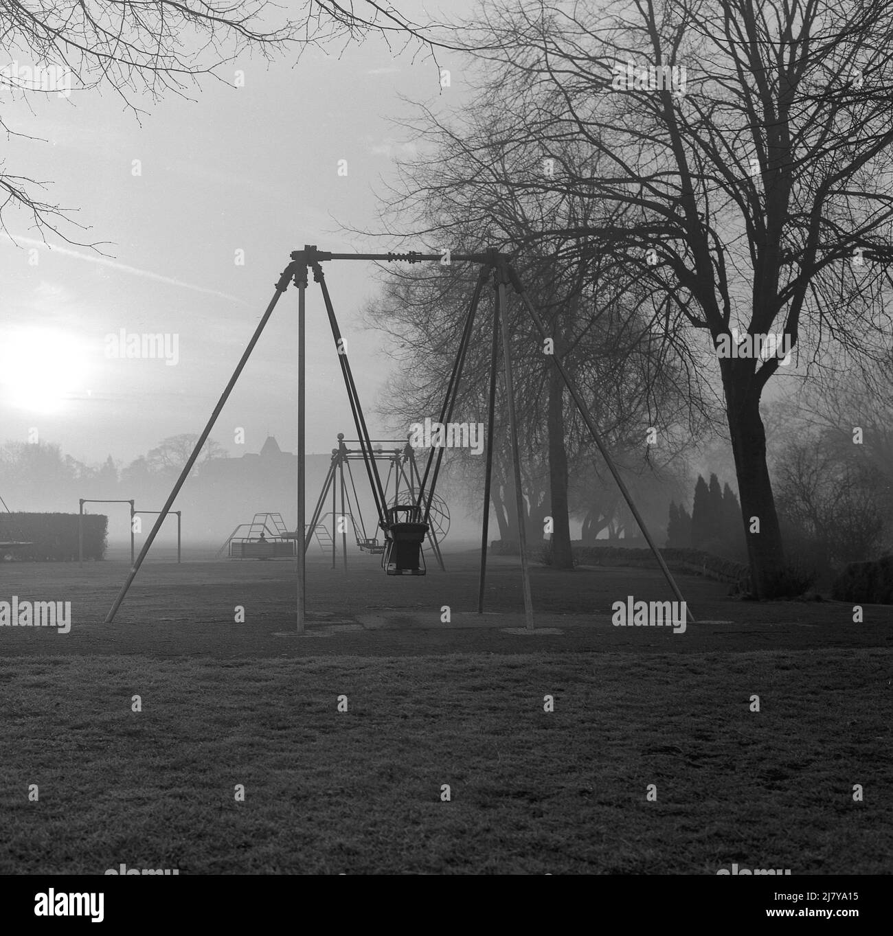1960s, historical, early morning and an empty playground in a park ...