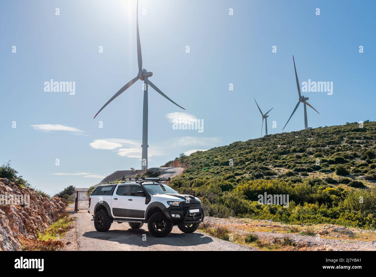 Custom made white pickup track with wind farm in background Stock Photo ...