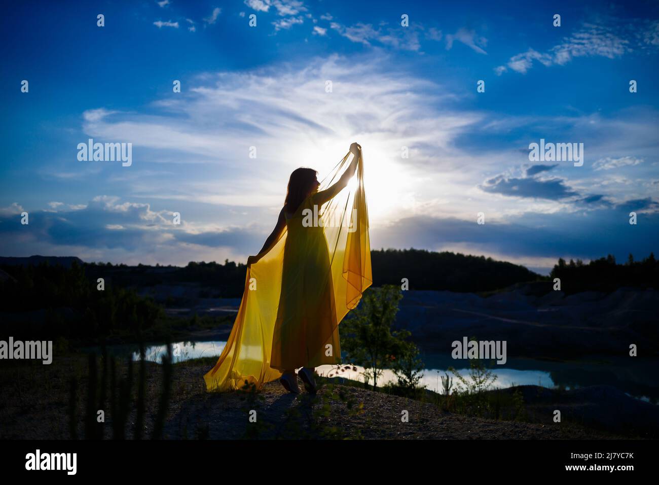 Happy Ukrainian woman running in nature. In a long yellow dress. Symbol ...