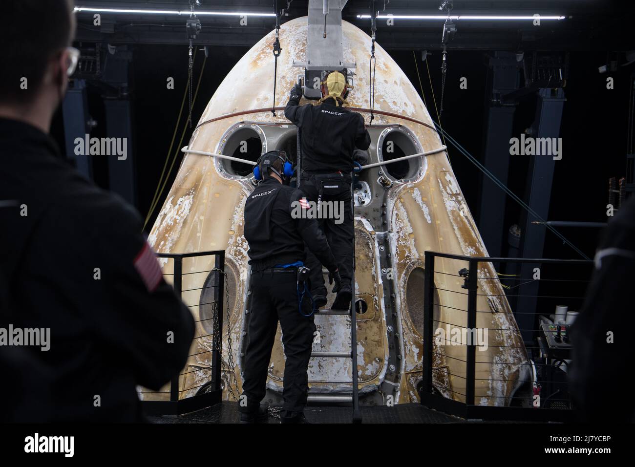Support teams prepare to open the hatch on the SpaceX Crew Dragon ...