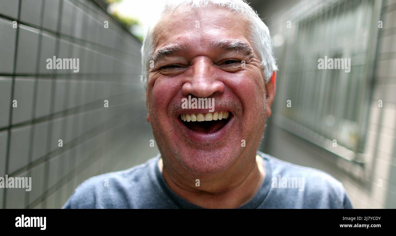 Casual older man laughing at camera, real people Stock Photo - Alamy