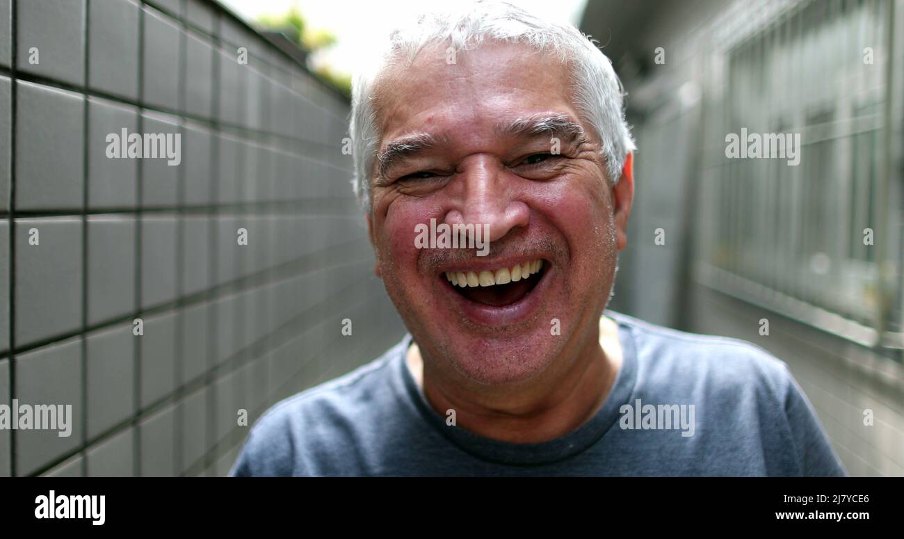 Casual older man laughing at camera, real people Stock Photo - Alamy