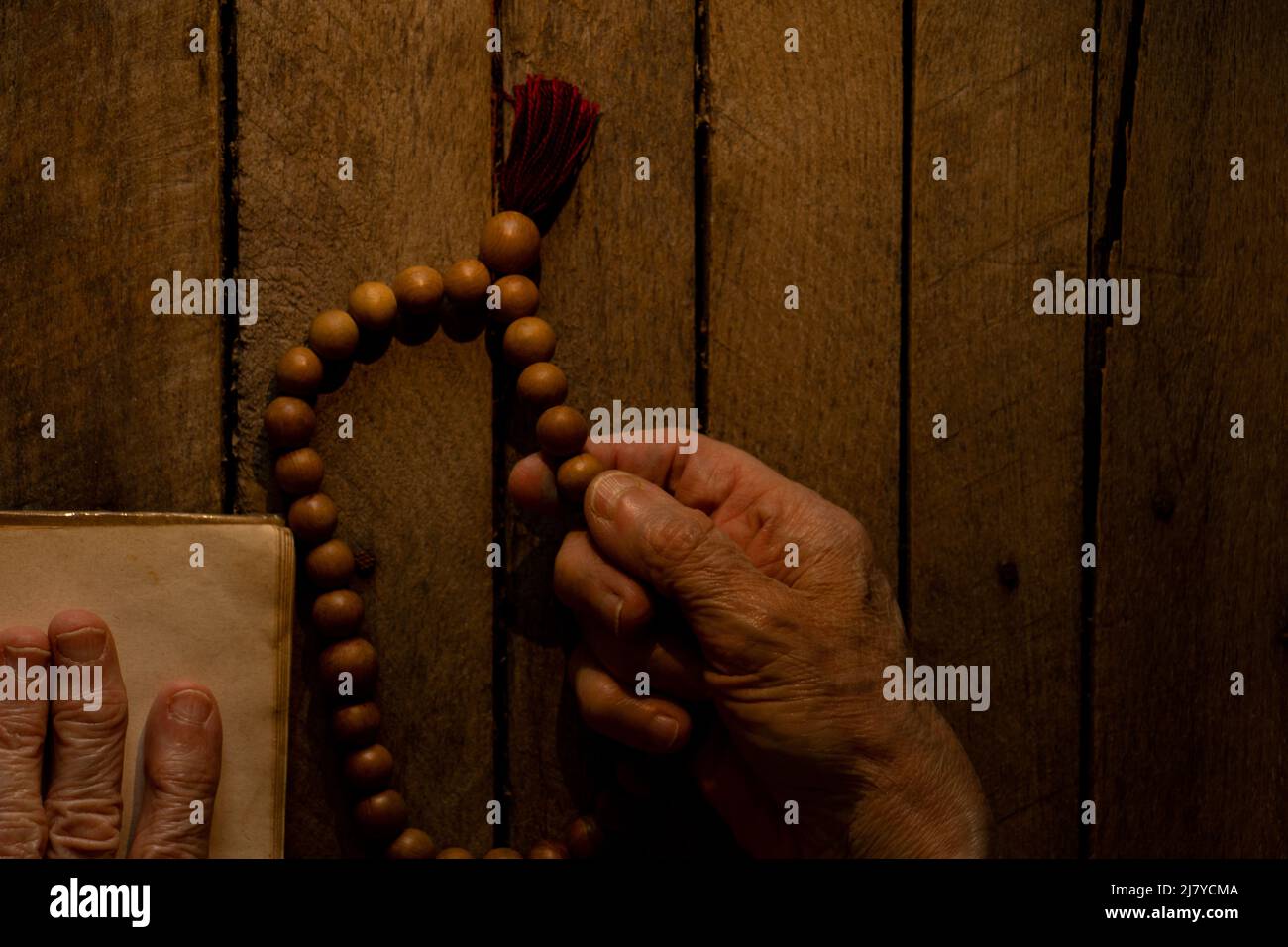 Old woman with wooden rosary and bible, woman praying, praying, faith ...
