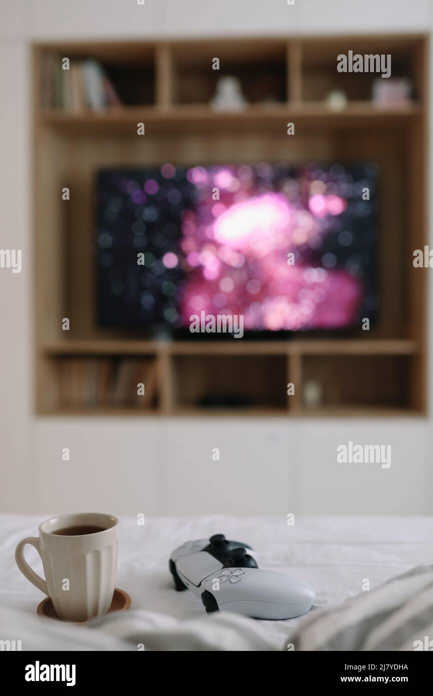 Game controller, joystick on TV screen background. Playing game console ...