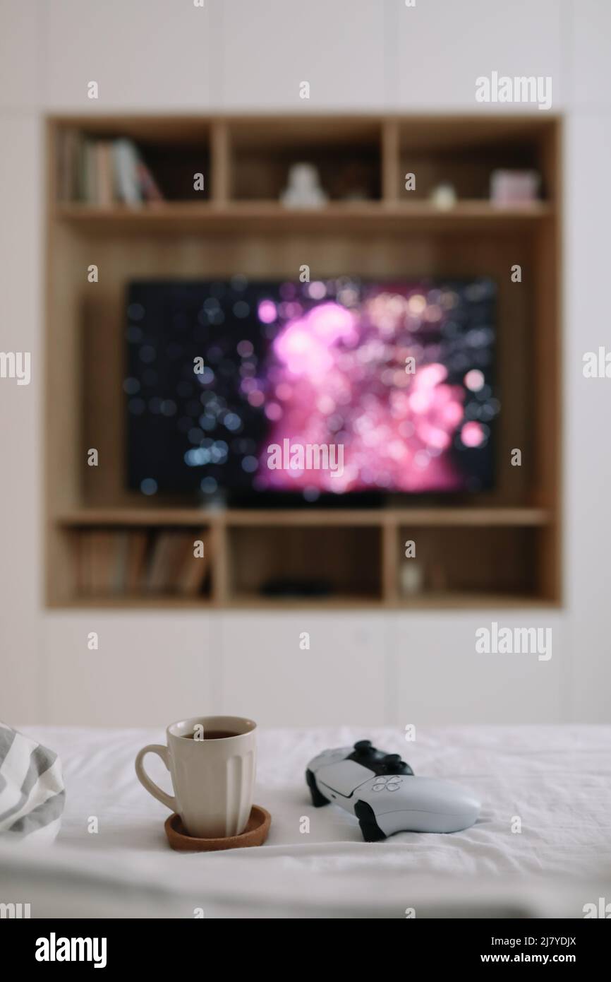 Game controller, joystick on TV screen background. Playing game console ...