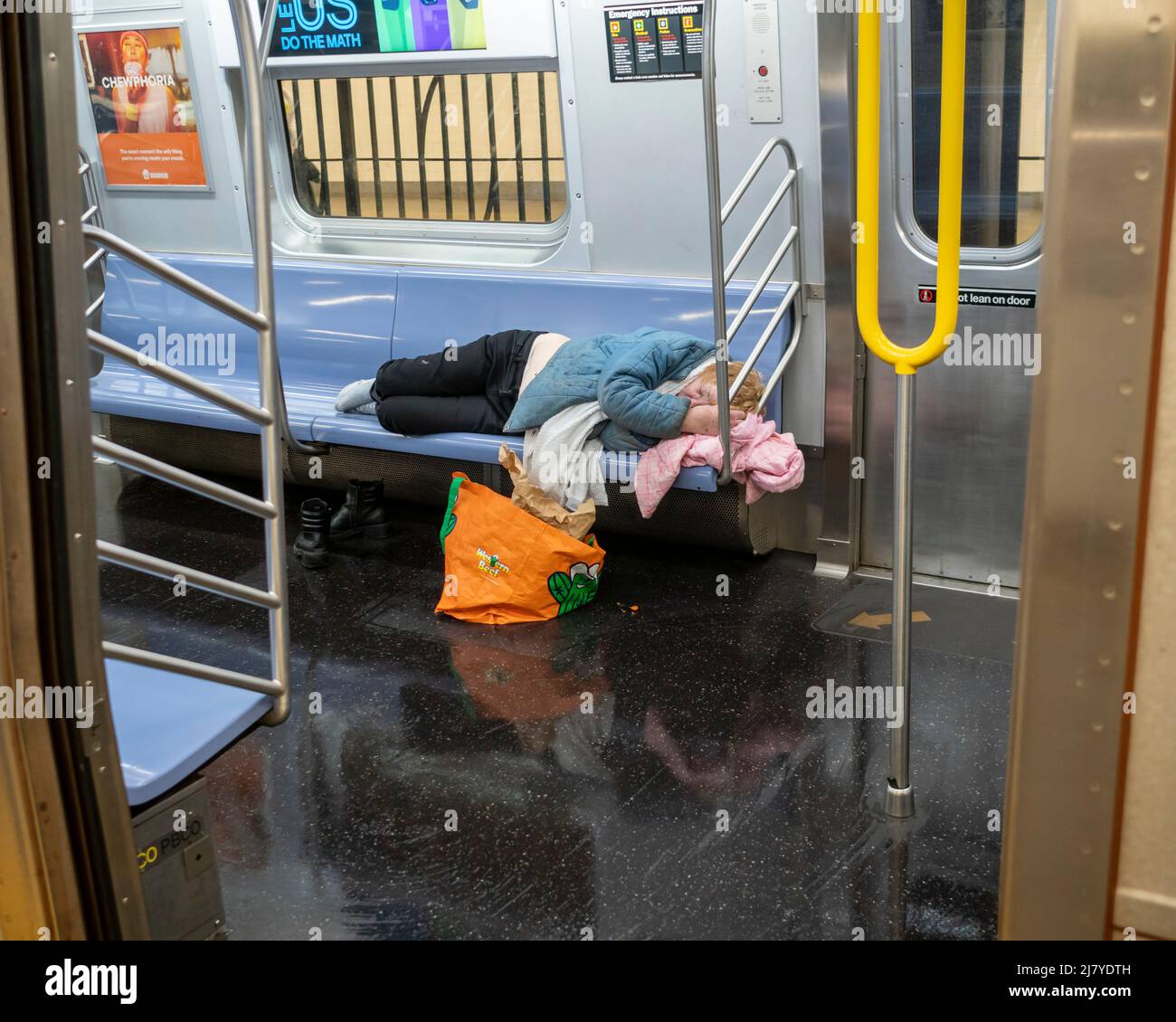 A Homeless Woman Sleeps On An E Line Subway Train In New York On