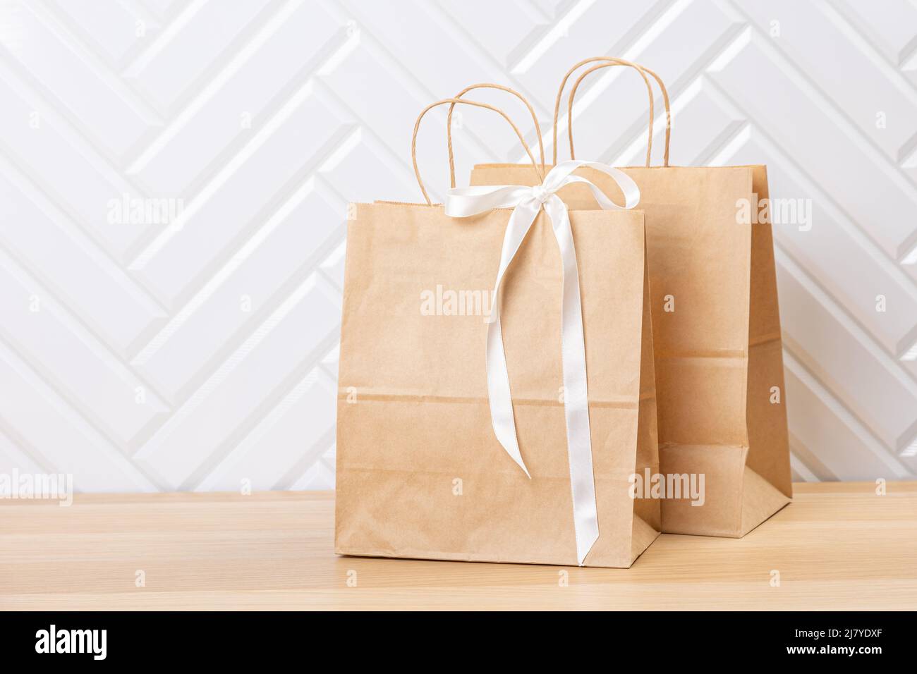 Blank paper carrier bag with handles for shopping, facing front on ...