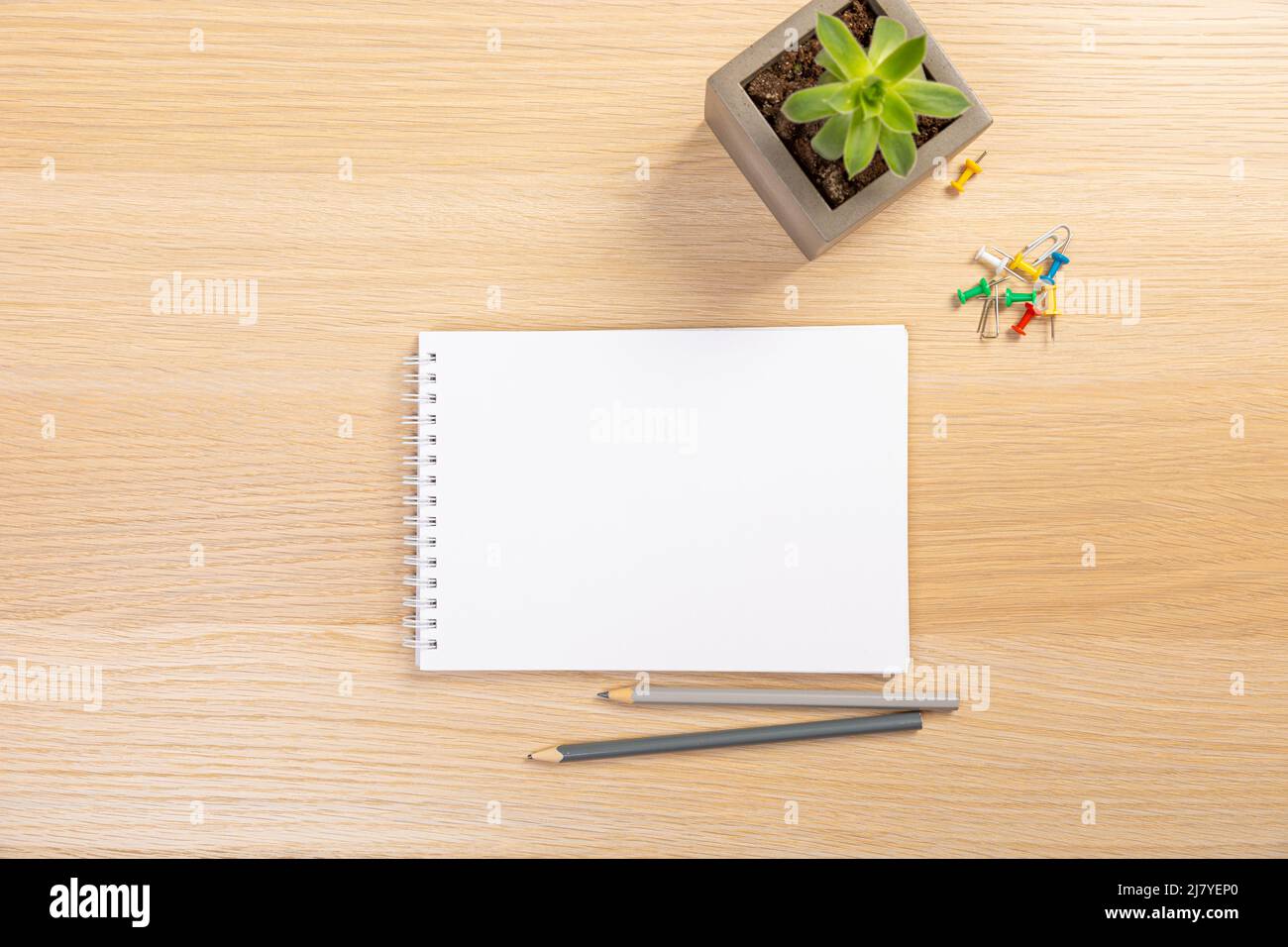 Working table with keyboard and notepad, pen, pencil and plant in home ...