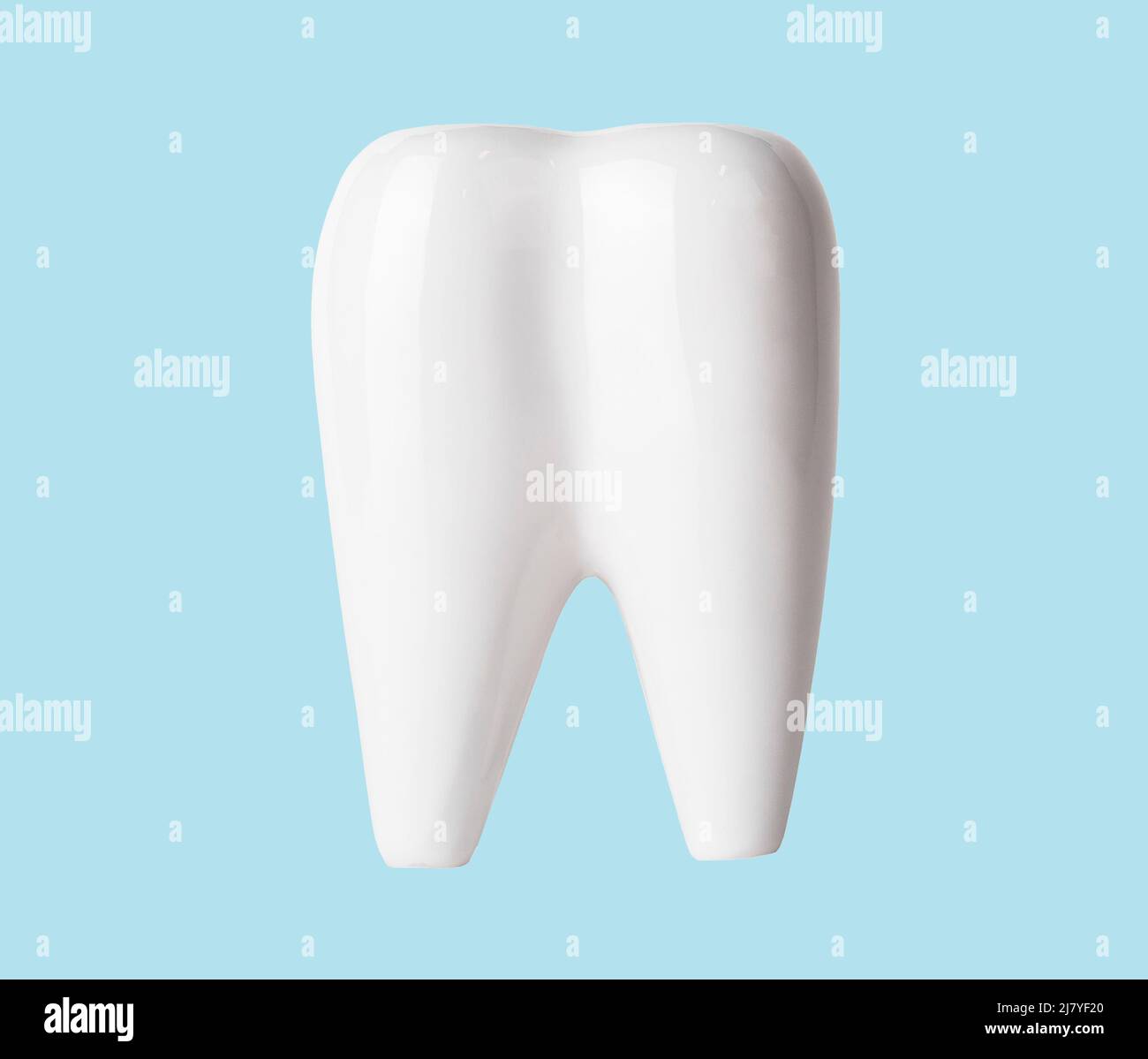 White healthy tooth on blue background. Oral care and dental health ...
