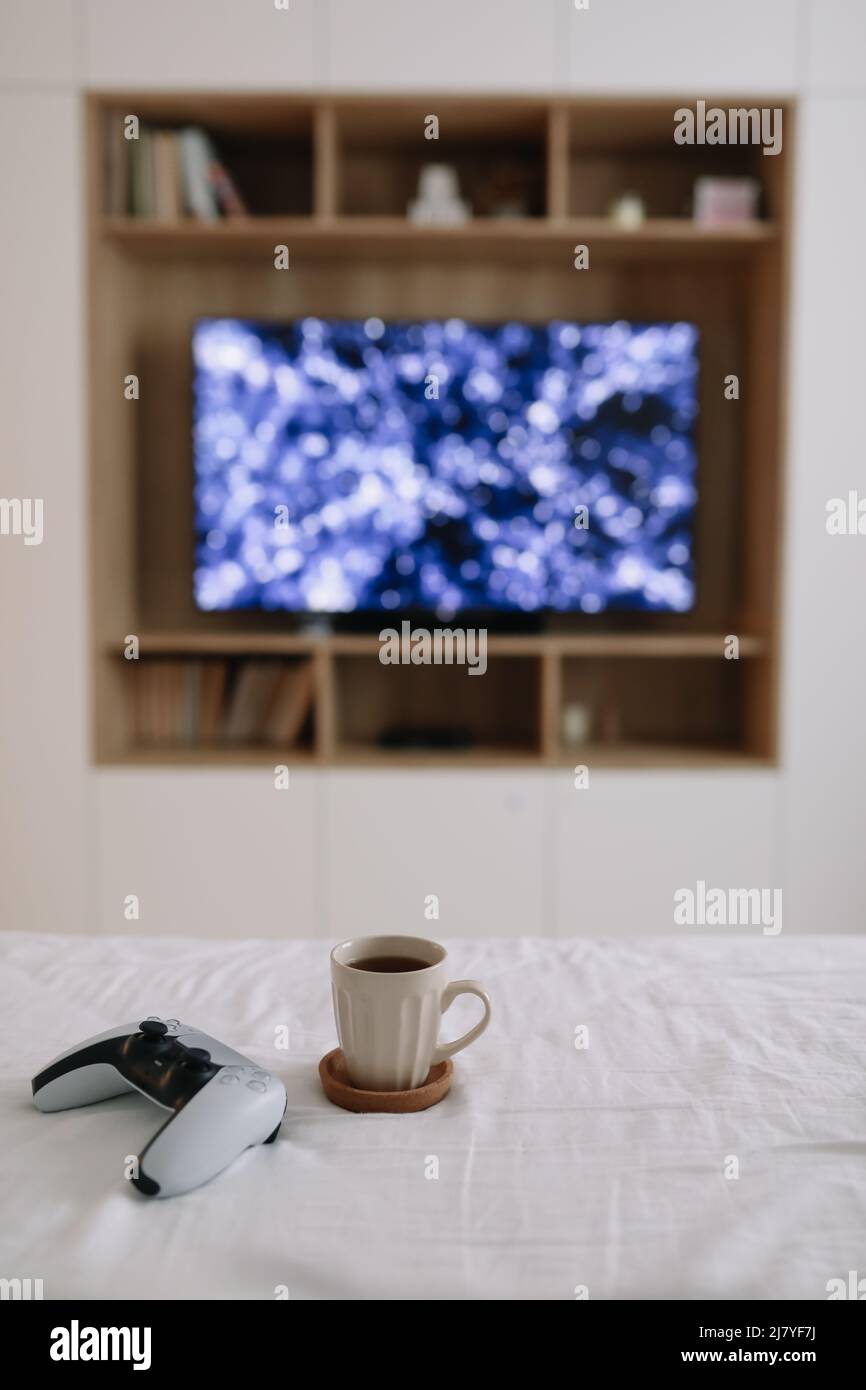 Game controller, joystick on TV screen background. Playing game console ...