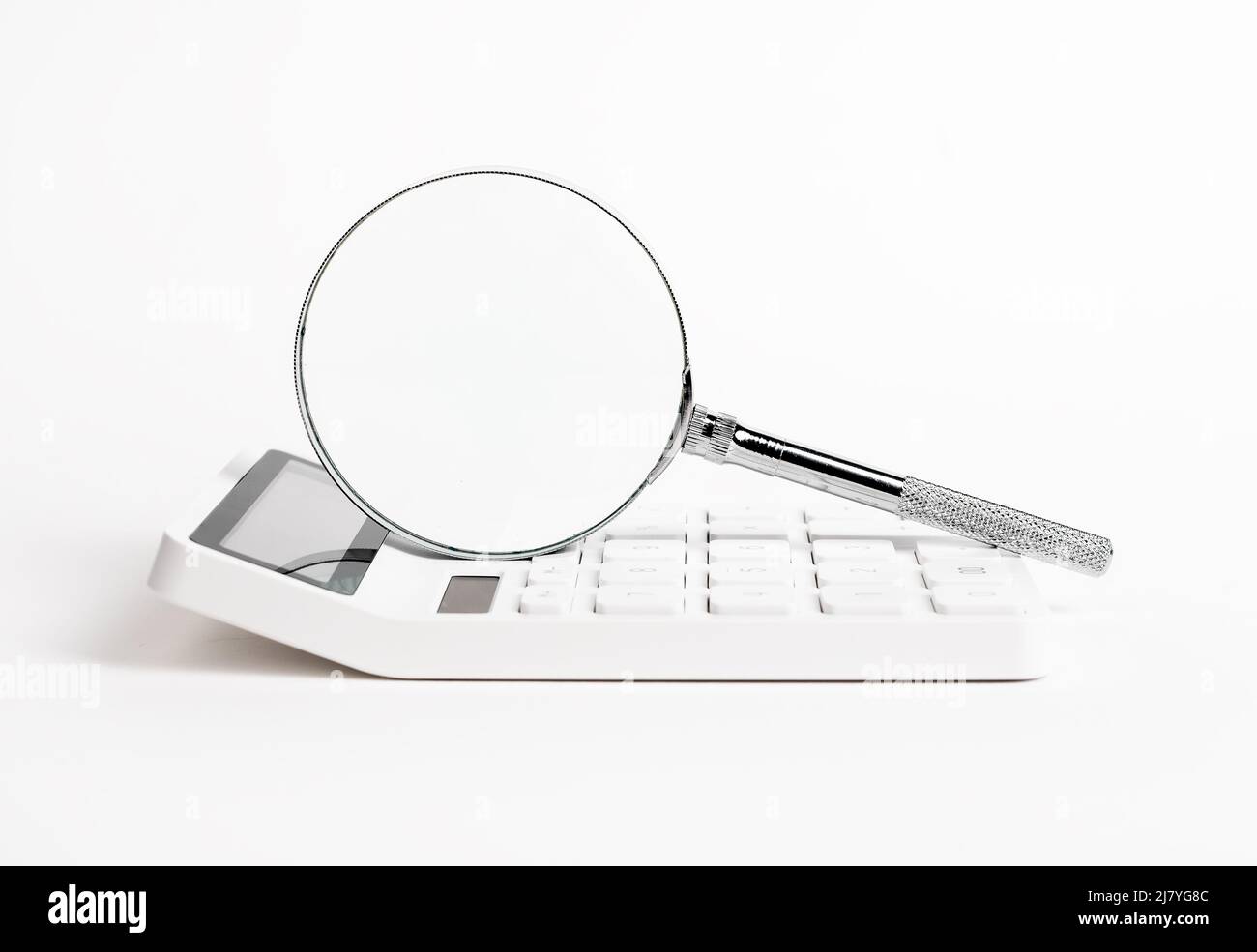 Magnifying glass with calculator. Statistics, financial data analysis ...