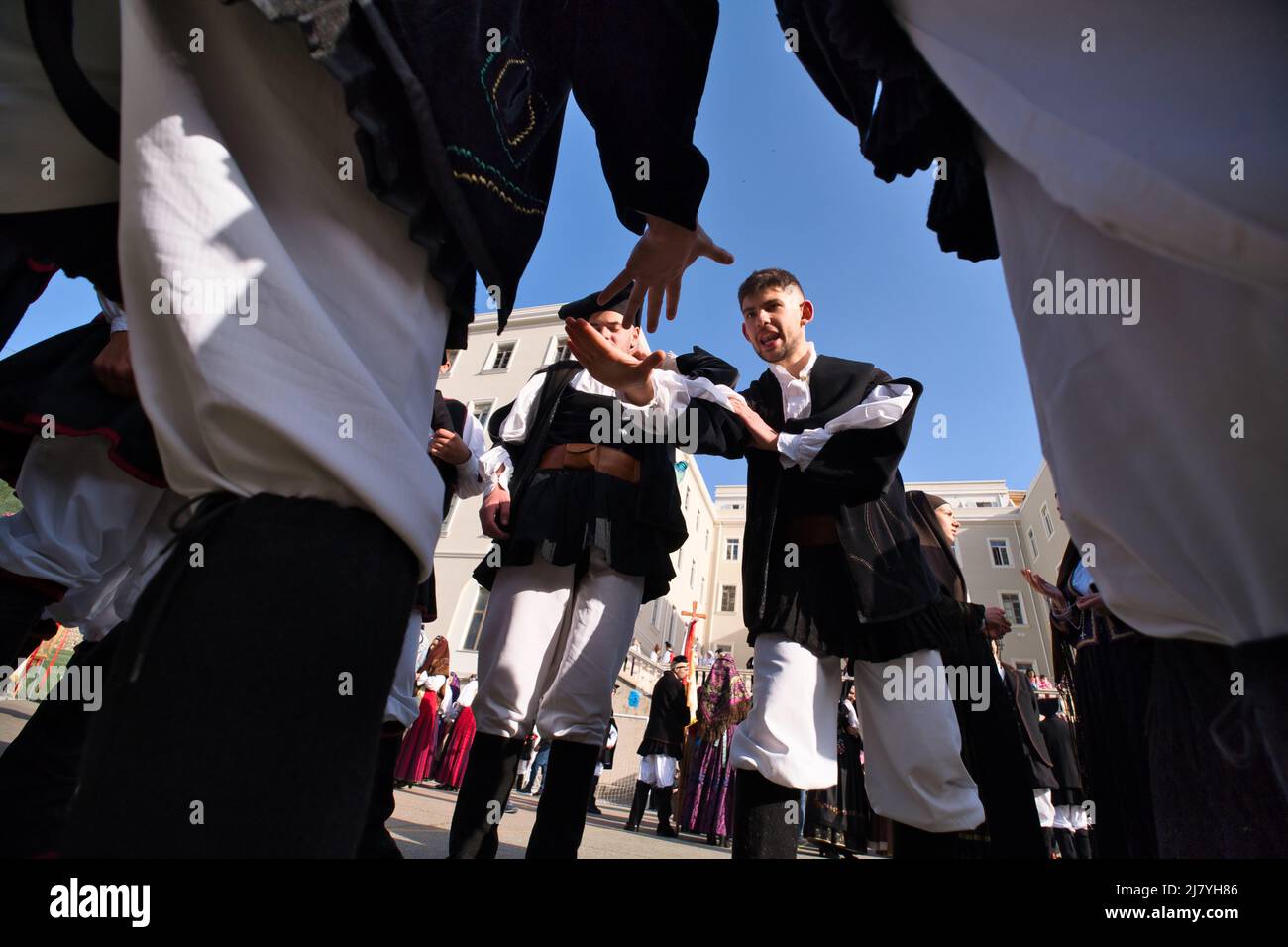 Low angle view of guys, wearing old style clothes, playing at "morra ...