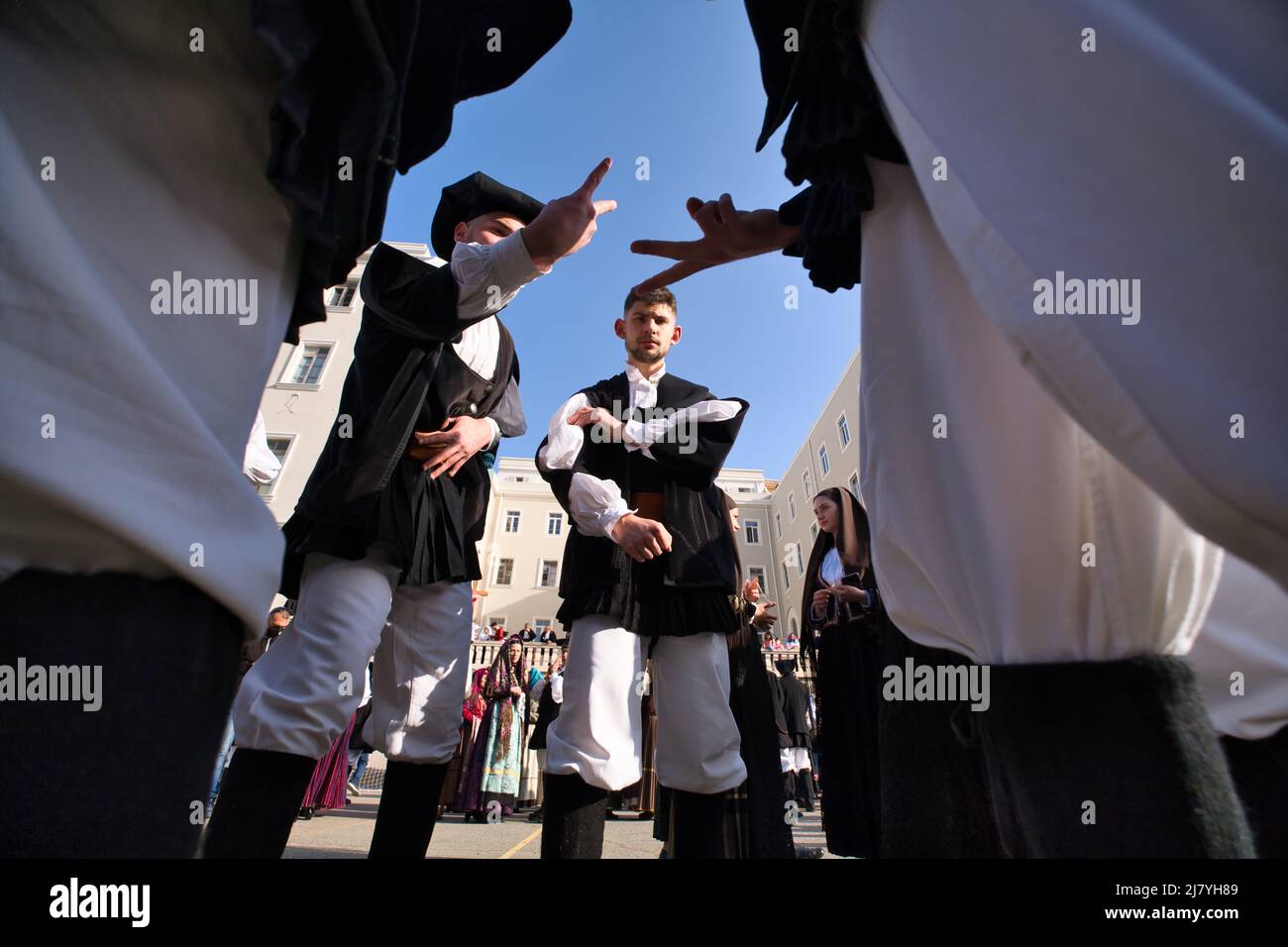 Low angle view of guys, wearing old style clothes, playing at "morra ...
