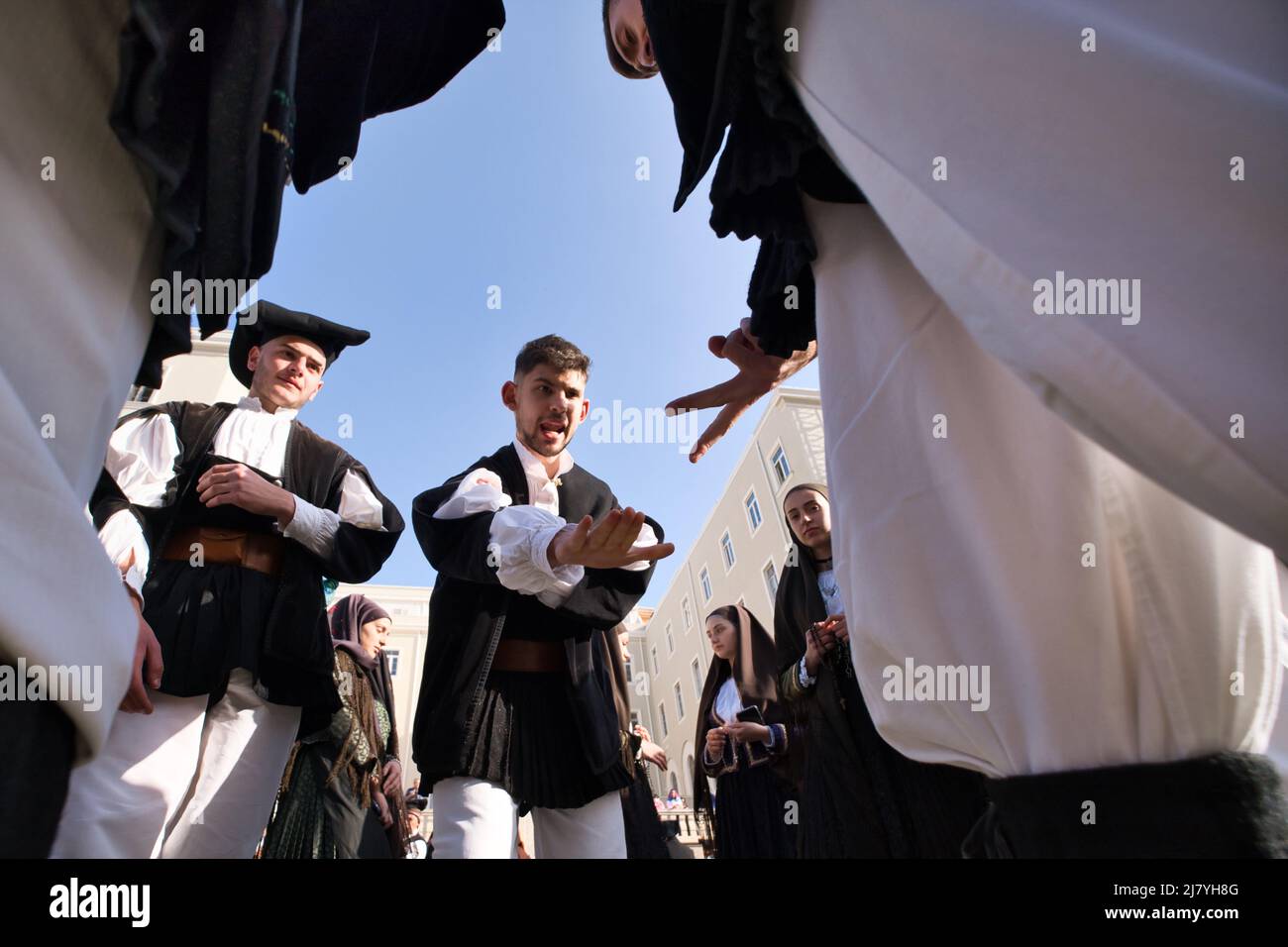 Low angle view of guys, wearing old style clothes, playing at "morra ...