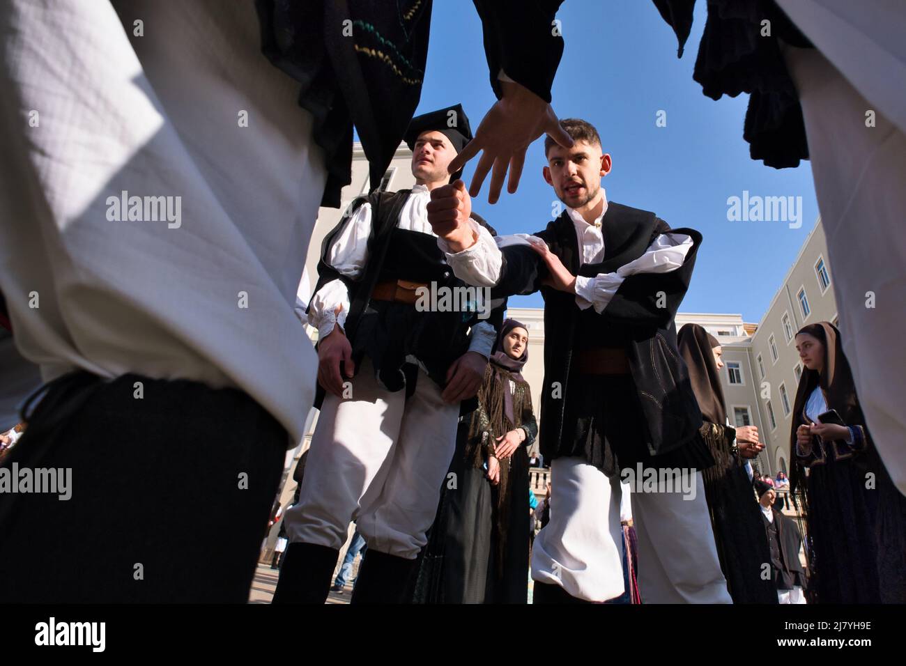 Low angle view of guys, wearing old style clothes, playing at "morra ...