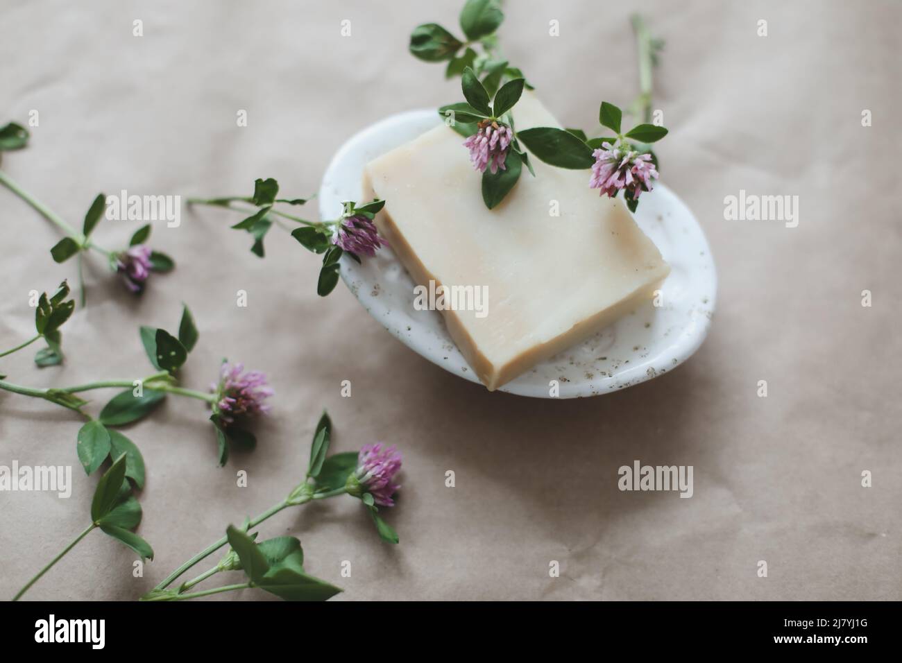 Handmade natural spa organic soap with flowers on ceramic soap dish on ...