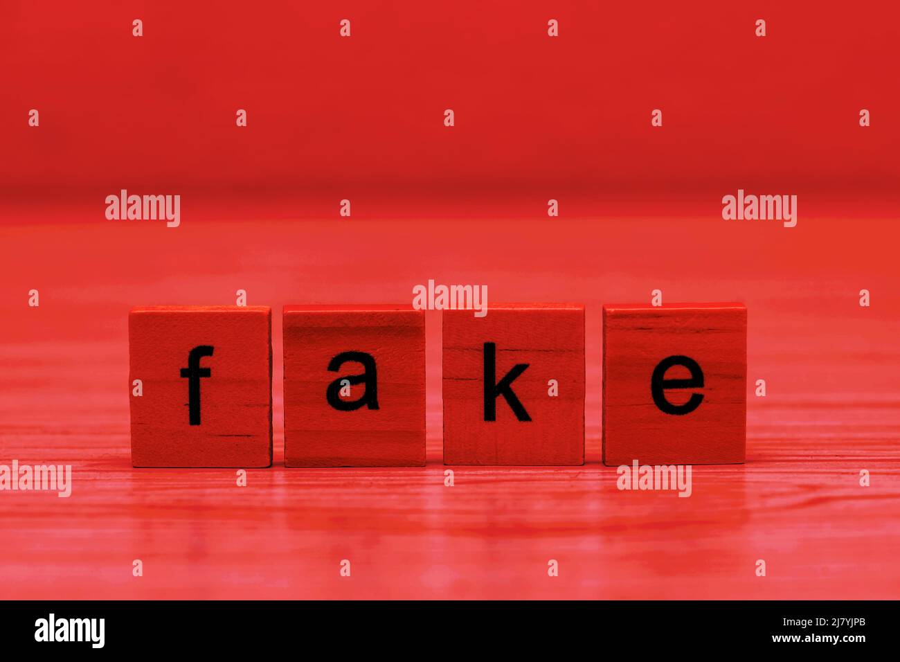 Wooden letters with text Fake news toned in red color. Journalism ...
