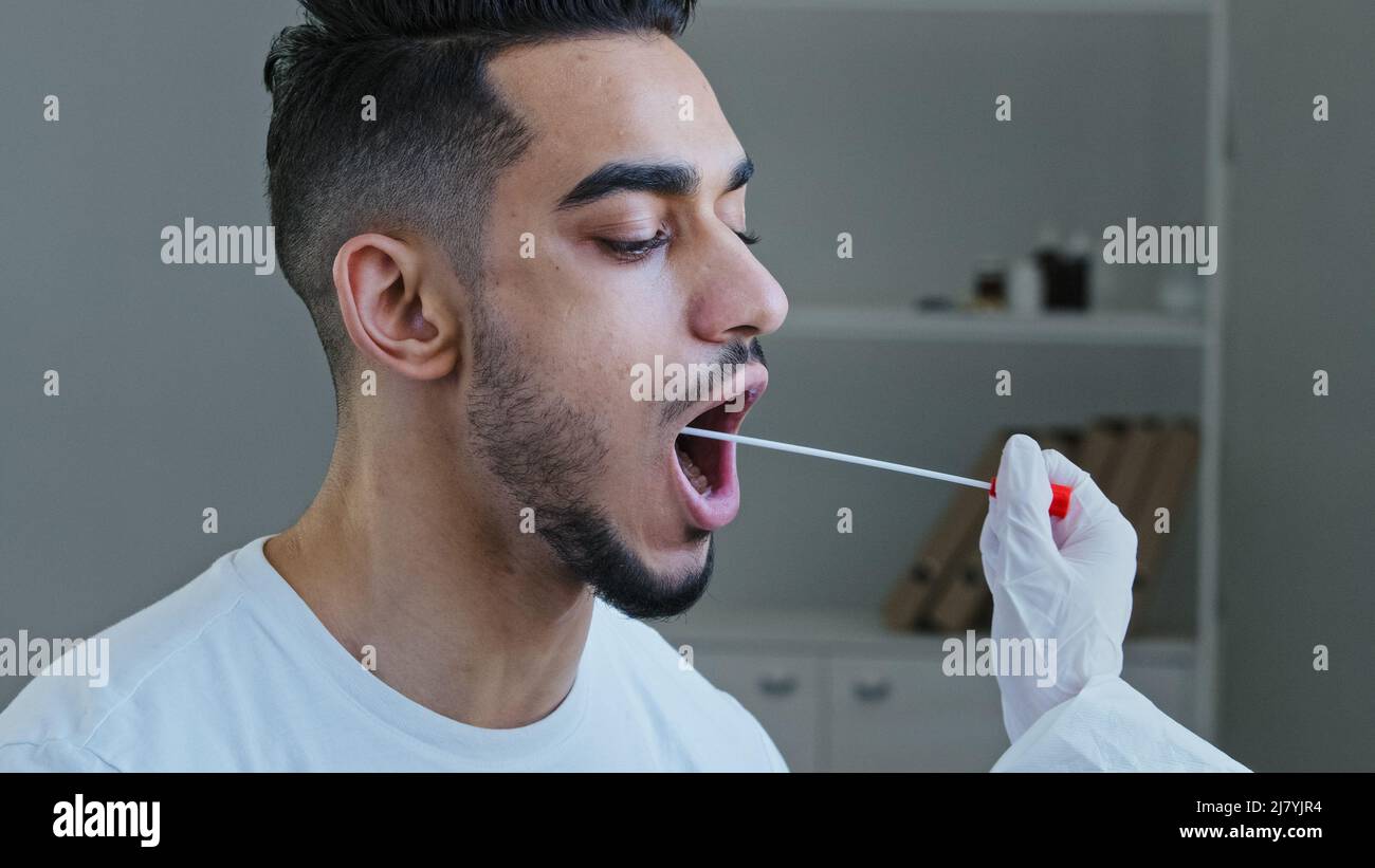 Close-up spanish man arabic male patient opens mouth donates saliva ...