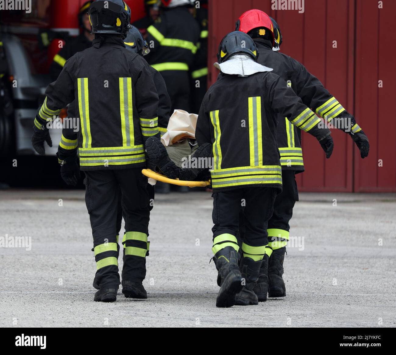 after the road accident, the firefighters carry the seriously injured ...