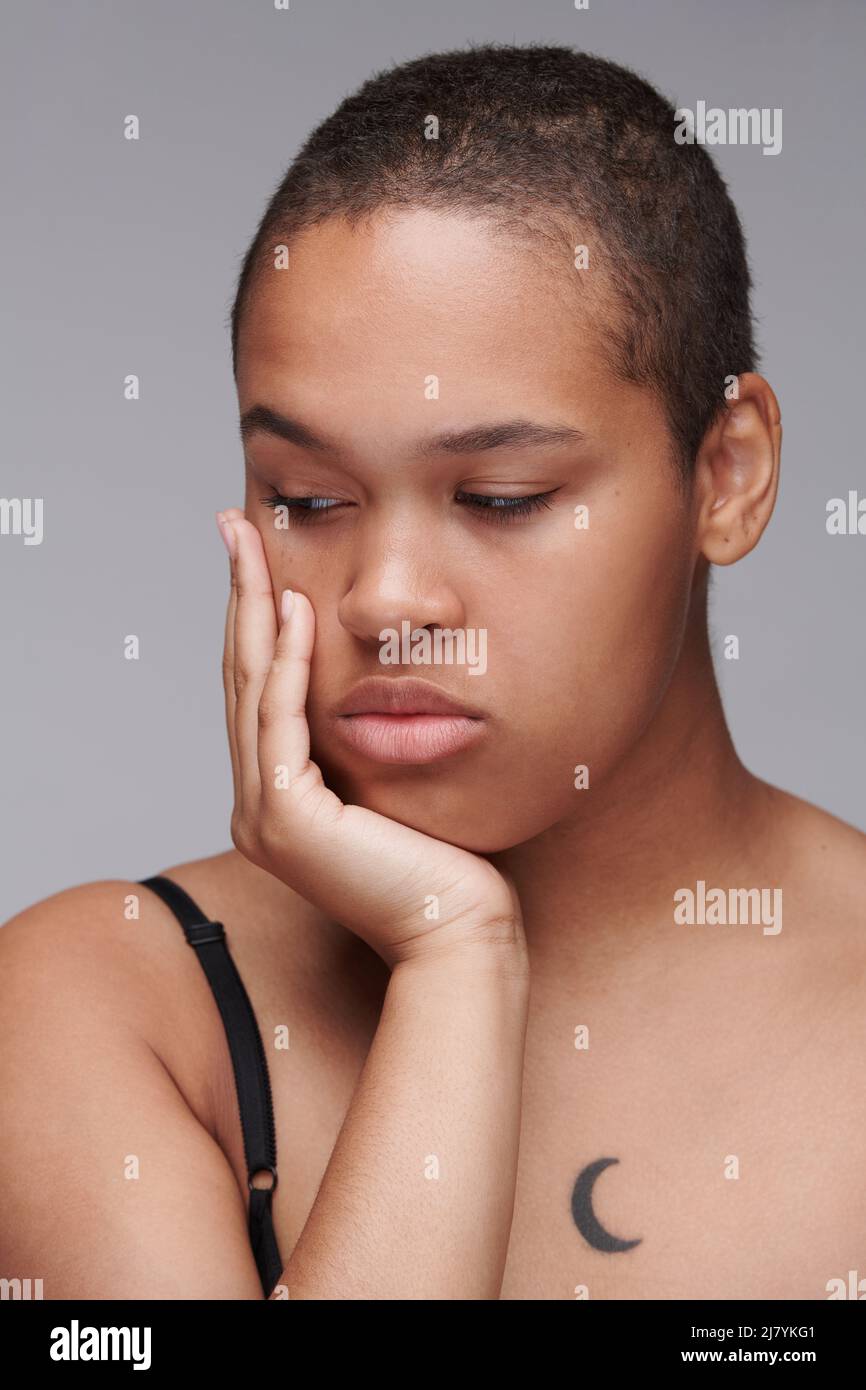 Sad beautiful young African-American woman with short hair having ...