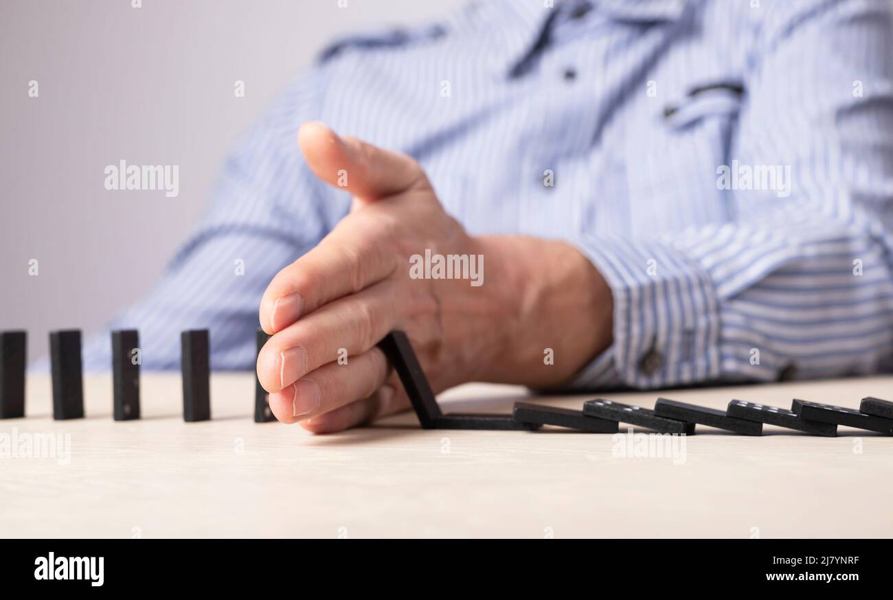 Business hand stop, preventing domino falling. Risk, fear, insurance ...