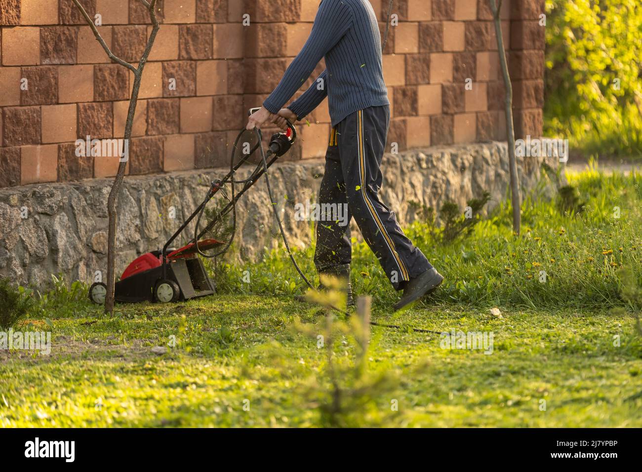 farmer mowing green grass with a scythe in the field Stock Photo - Alamy
