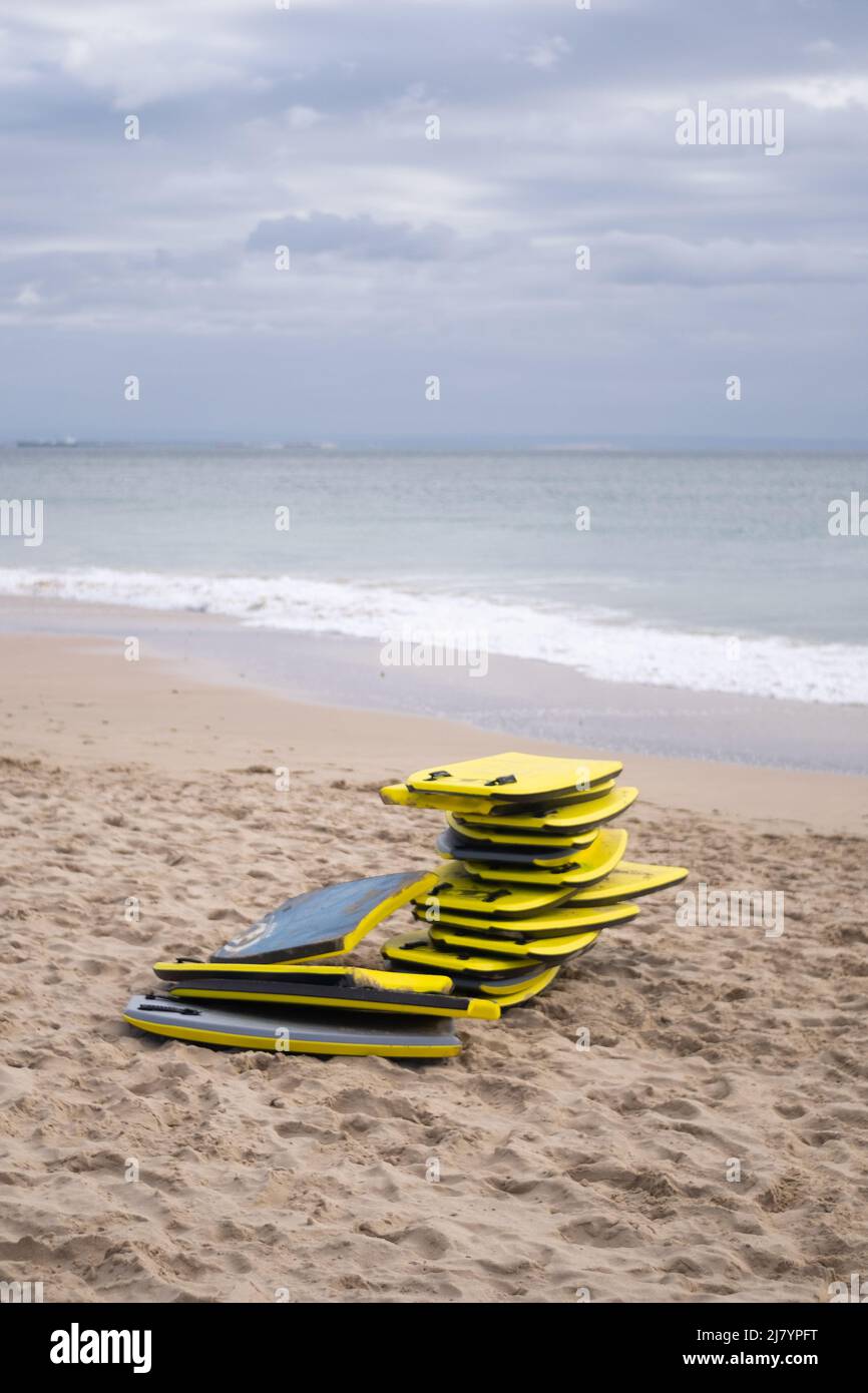A bunch of beach body boards stacked up Stock Photo - Alamy