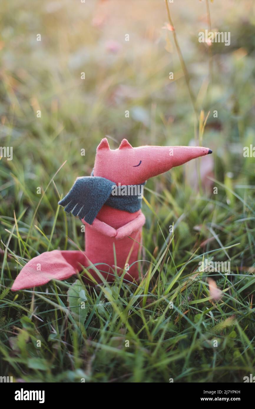 Cute little handmade toy fox in green grass. Childhood, baby, holiday ...