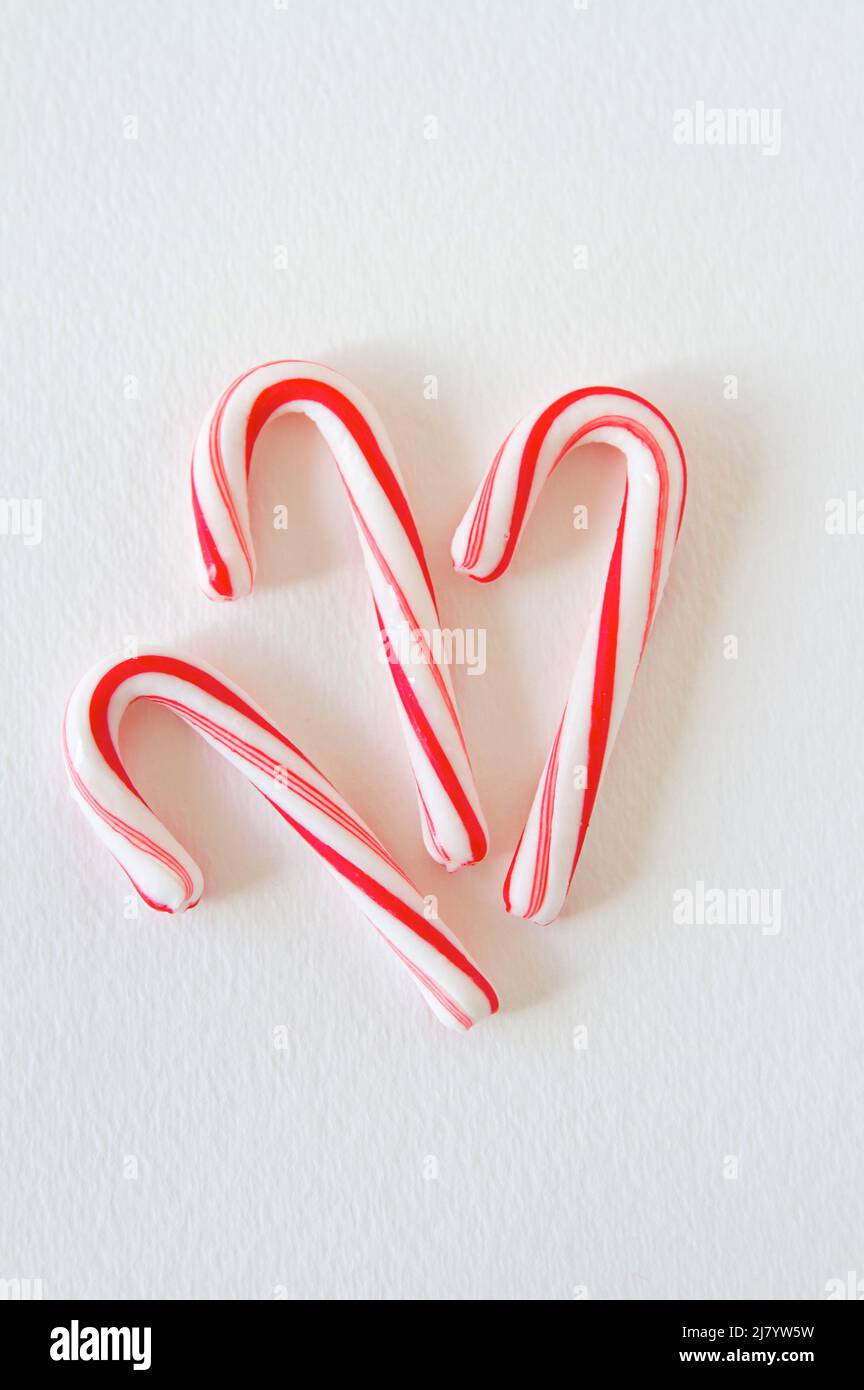 Three striped candy canes on a vertical white background, photo taken ...