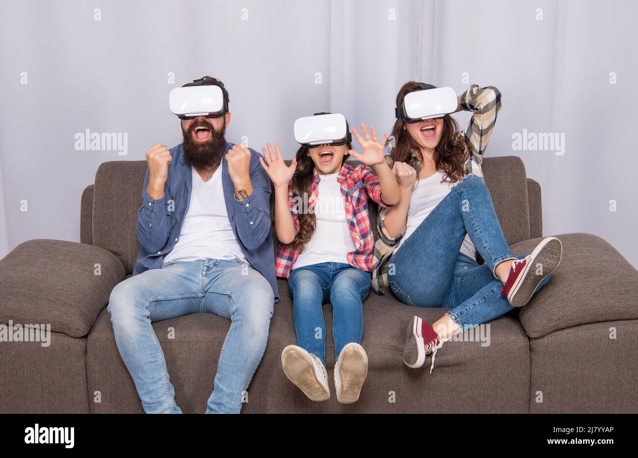 father mother and child wireless VR glasses. virtual reality family ...