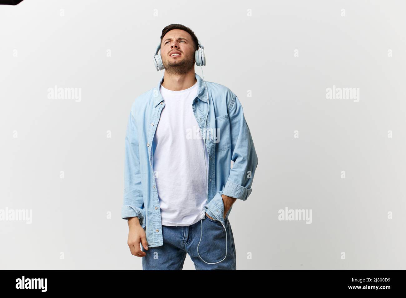 Tired unhappy frustrated tanned handsome man in casual basic t-shirt ...