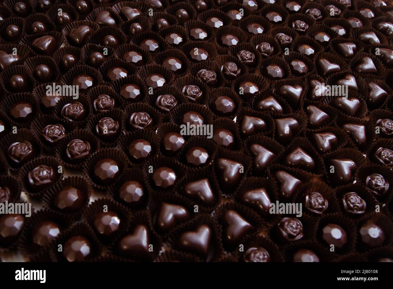 Lots of handmade chocolate candies with filling in a chocolate factory ...