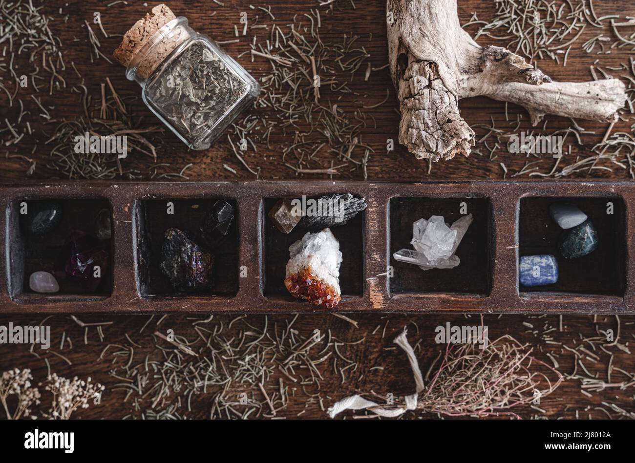 Flat lay shot of a collection of many different crystals on a messy ...
