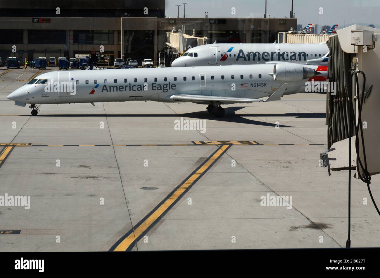 An American Airlines and an American Eagle passenger aircraft taxi ...