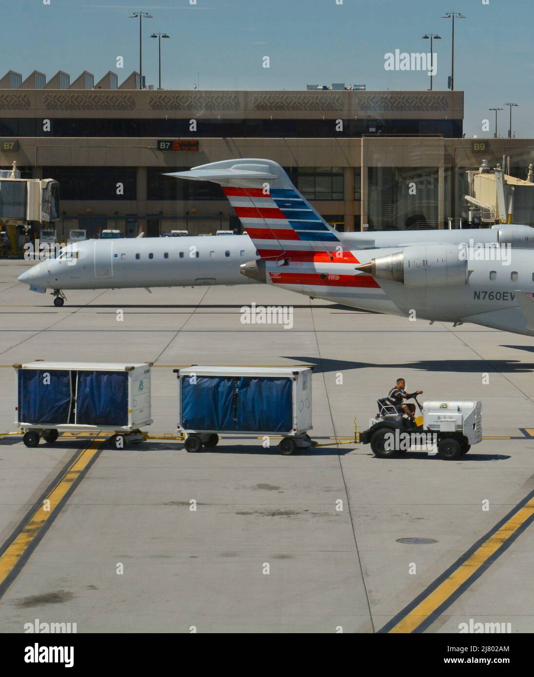 Ground crew members work on the tarmac as American Airlines and ...