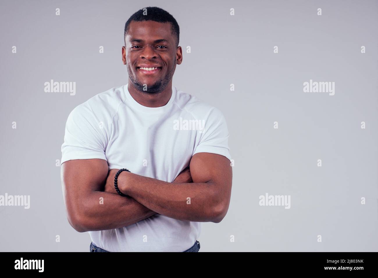 African American healthy male model in a cotton white t-shirt in studio ...