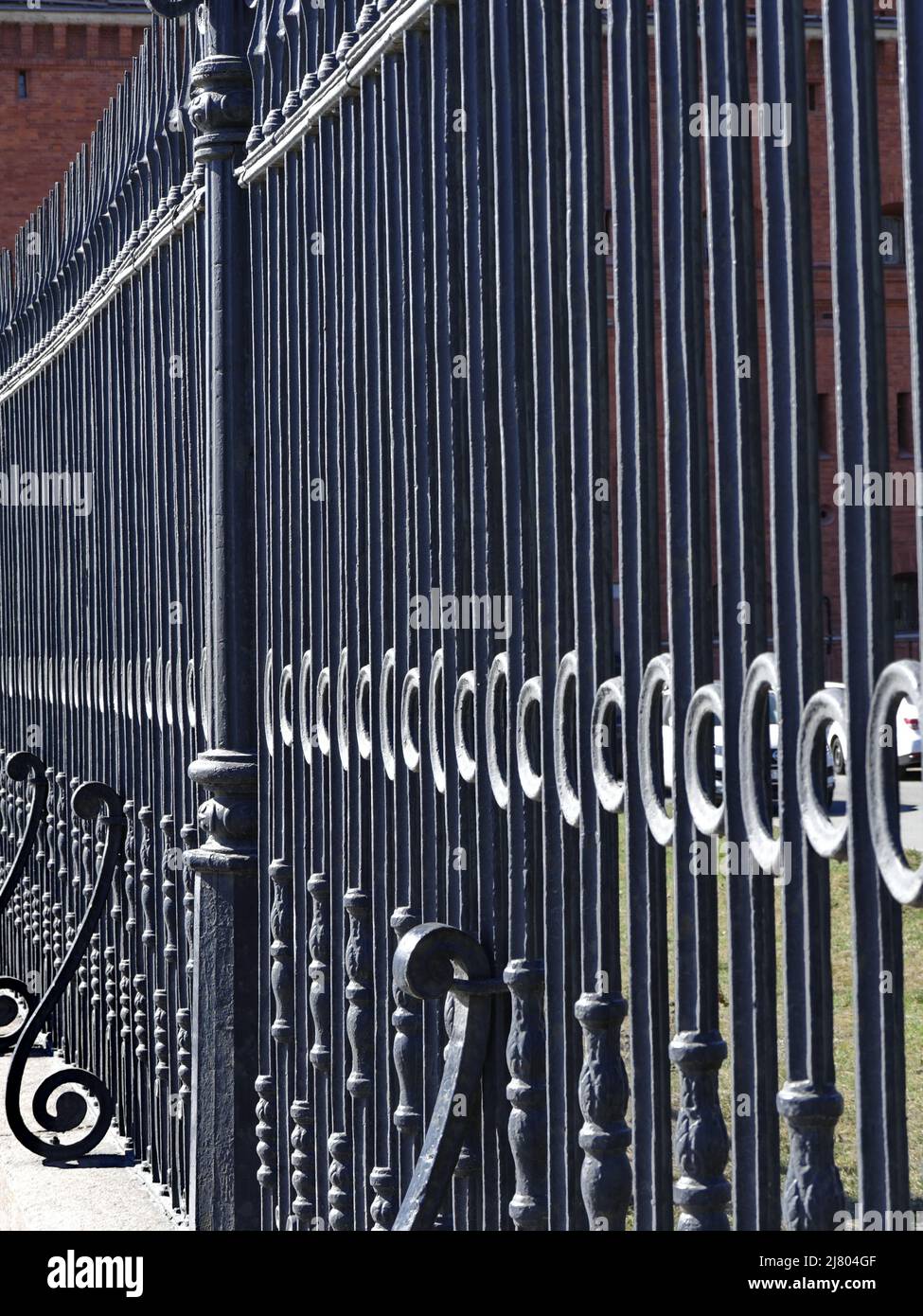 Antique cast iron high fence perspective Stock Photo - Alamy