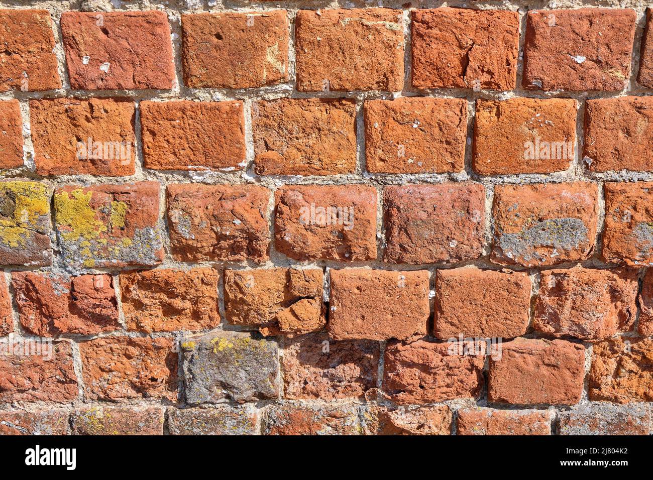 Red brick pattern. An old brick wall with cracks and scratches. A wall ...