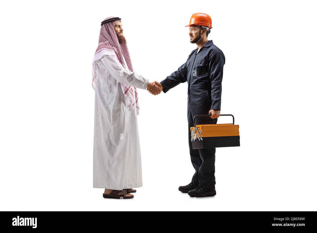 Full length profile shot of worker in a uniform and helmet shaking ...