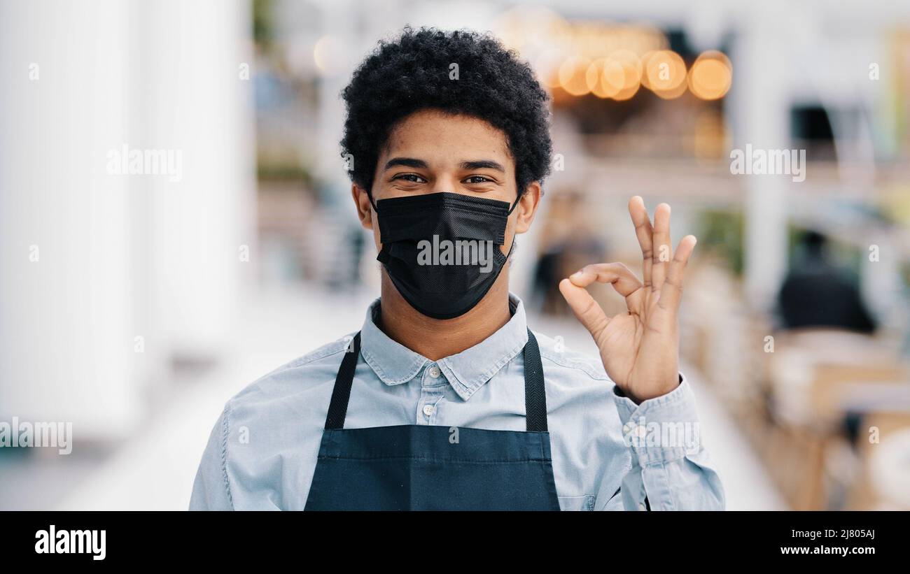 Masked african american male cafe worker waiter salesman in apron ...