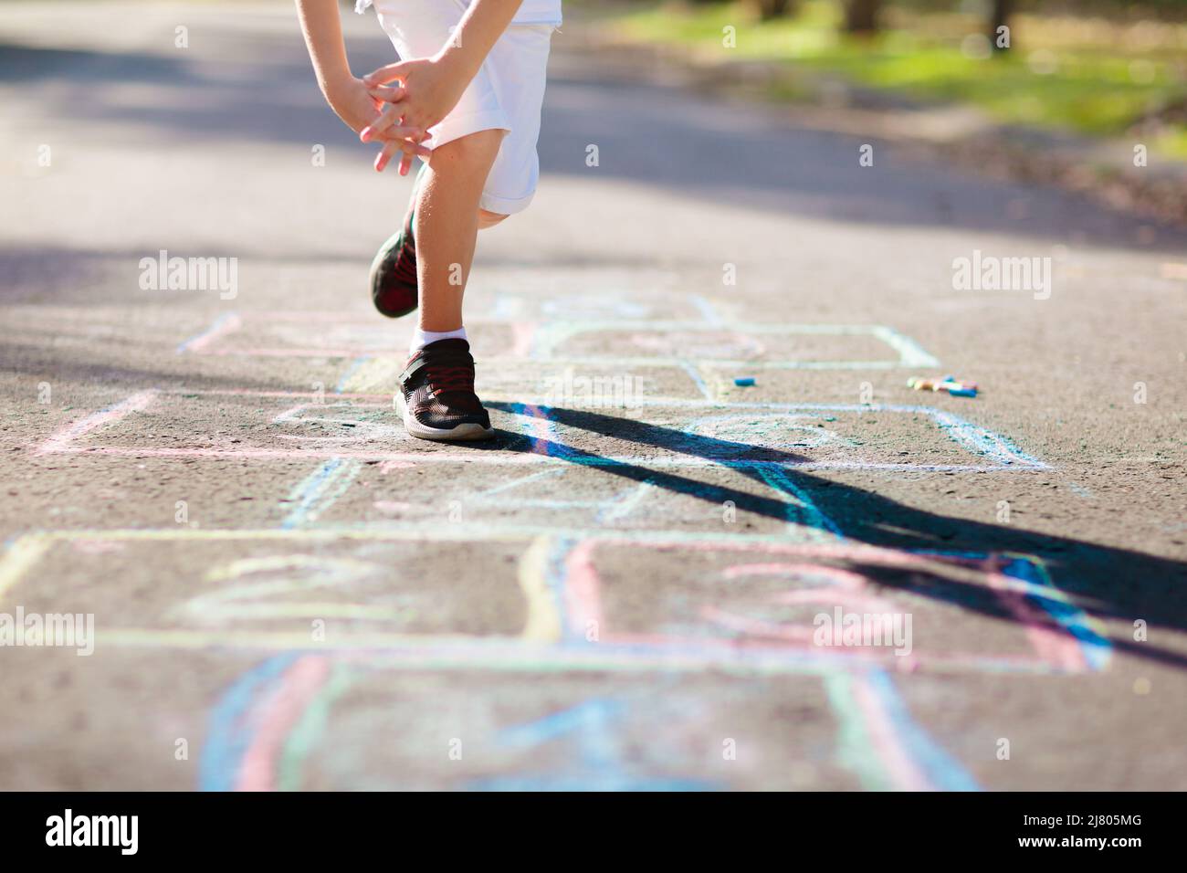 Kids play hopscotch in summer park. Healthy active outdoor game ...