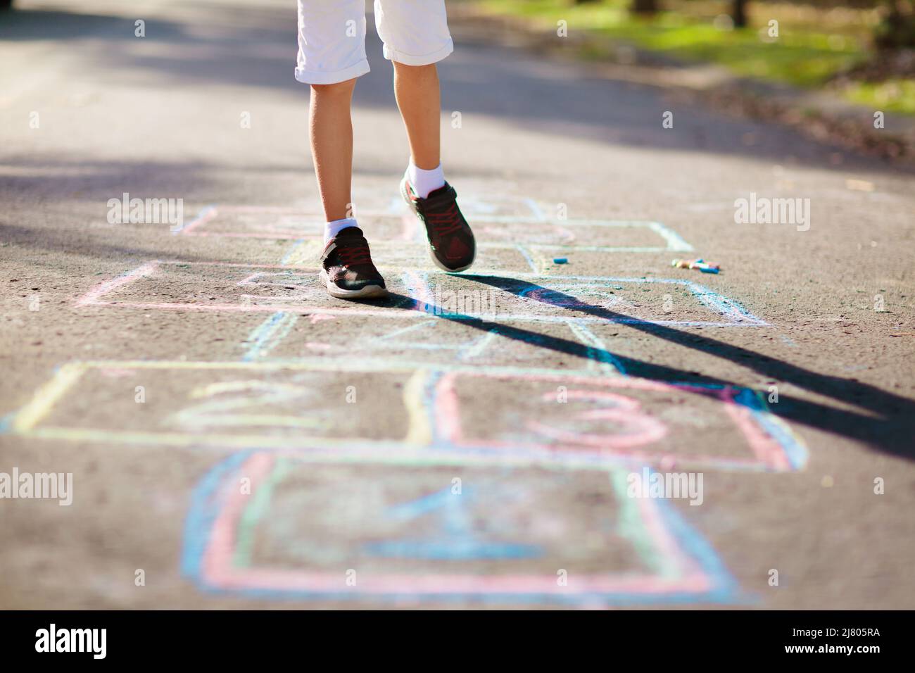Kids play hopscotch in summer park. Healthy active outdoor game ...