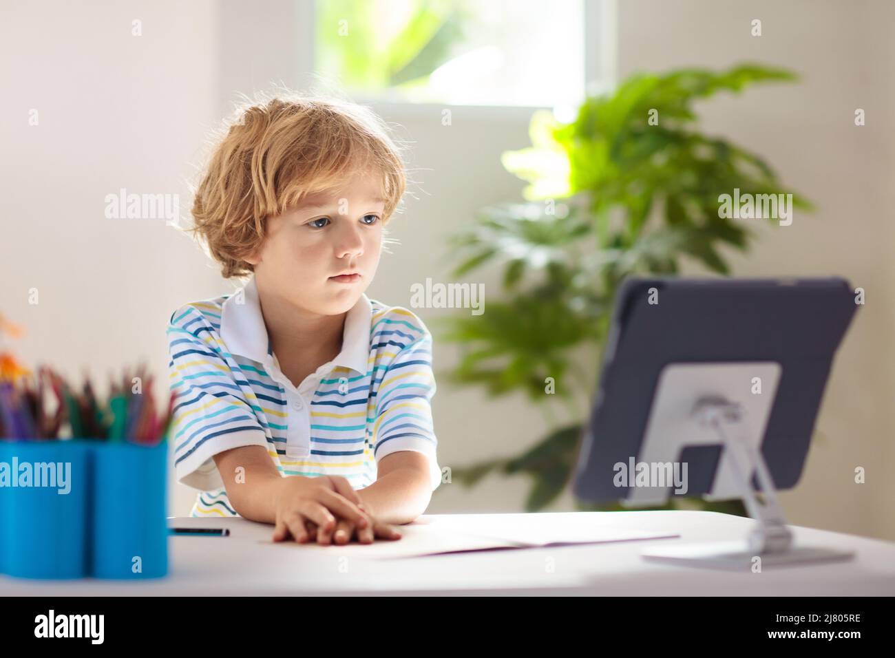 Online remote learning. School kids with computer having video ...