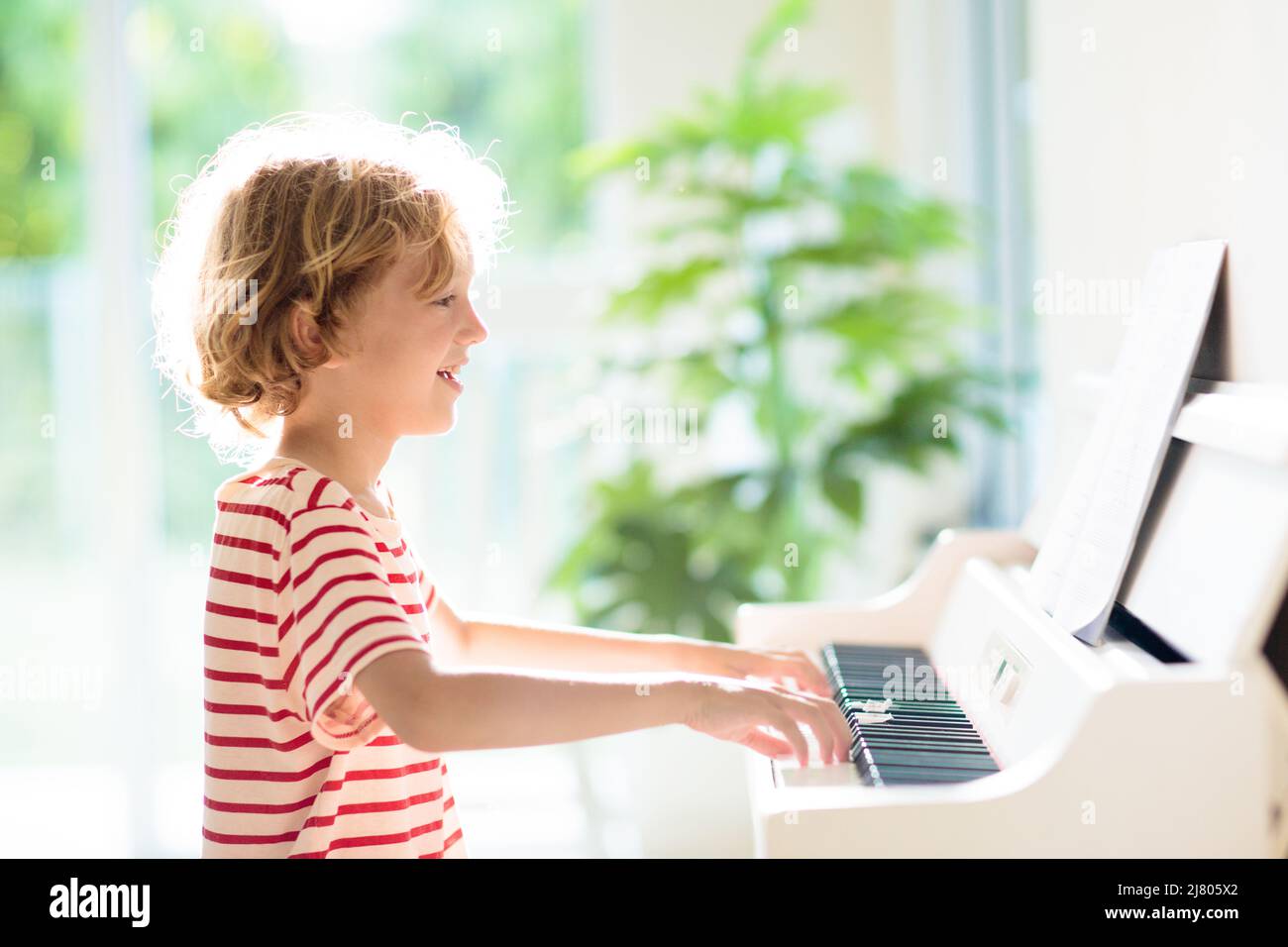 Child playing piano. Kids play music. Classical education for children ...