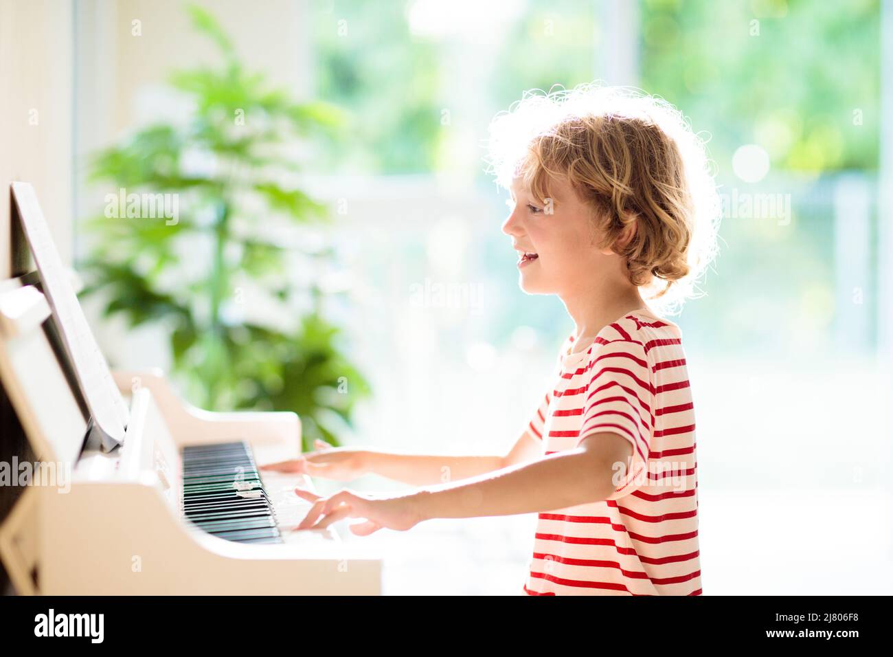 Child playing piano. Kids play music. Classical education for children ...