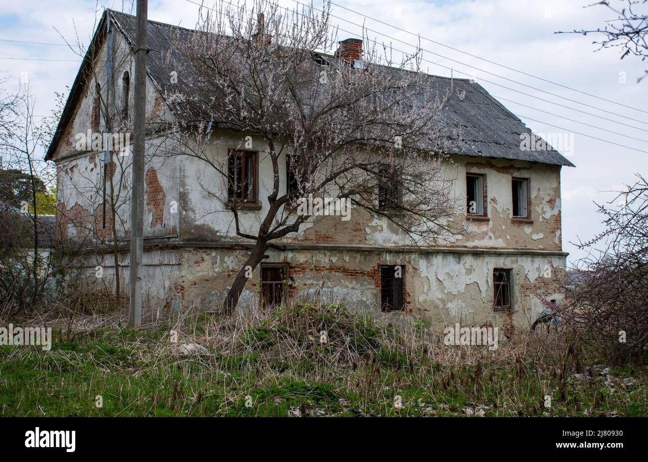 abandoned empty house with empty windows and peeled walls Stock Photo ...